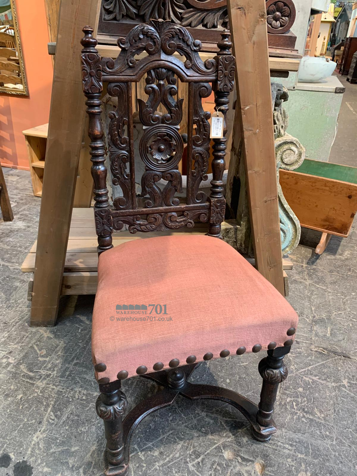 Dark wood relief carving chair with padded seat