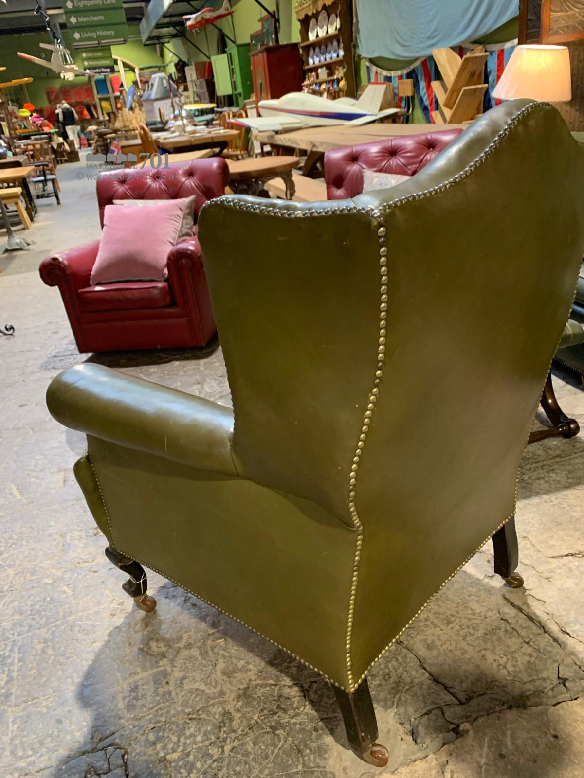 Vintage green leather wing back chair