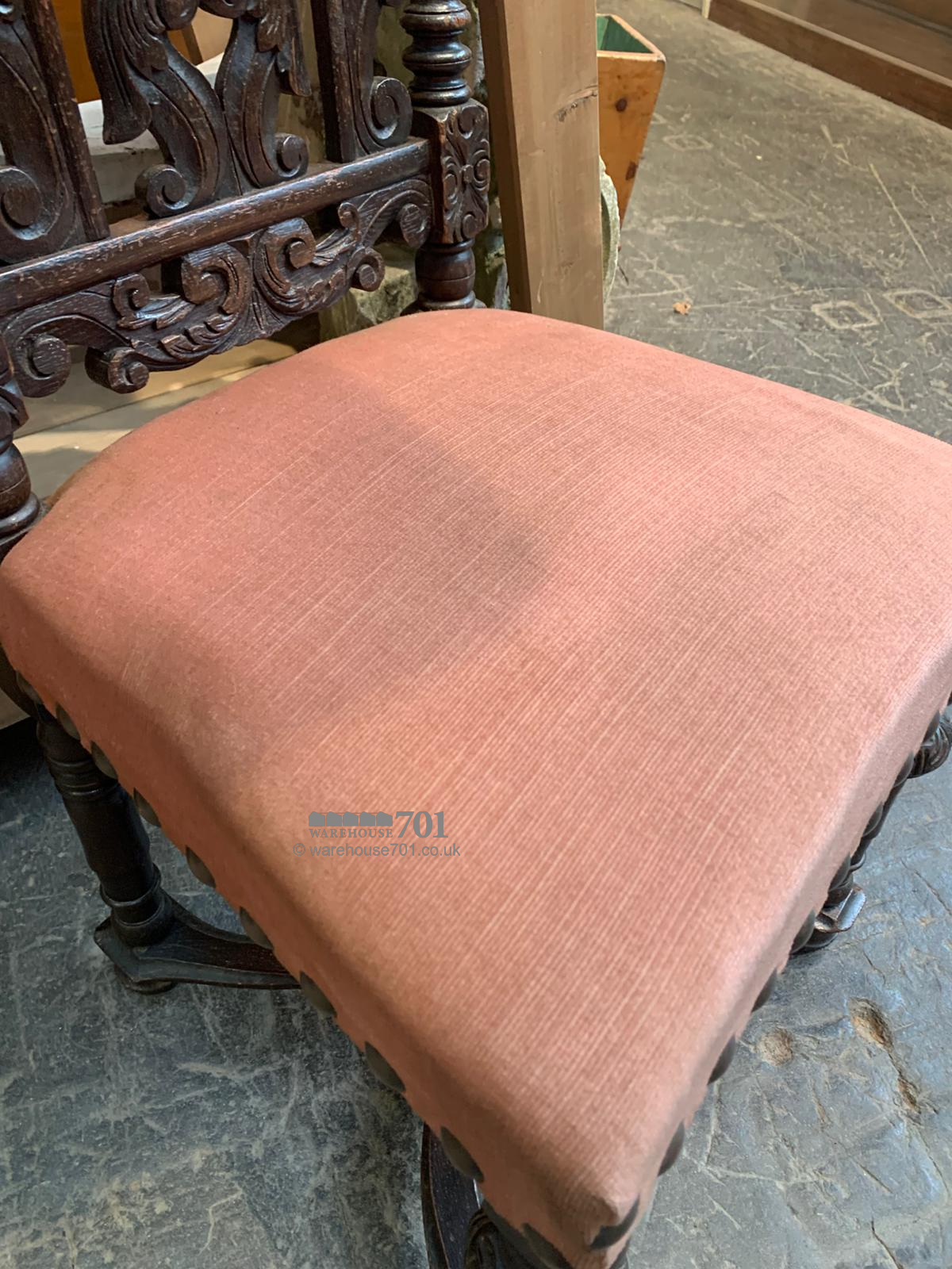 Dark wood relief carving chair with padded seat