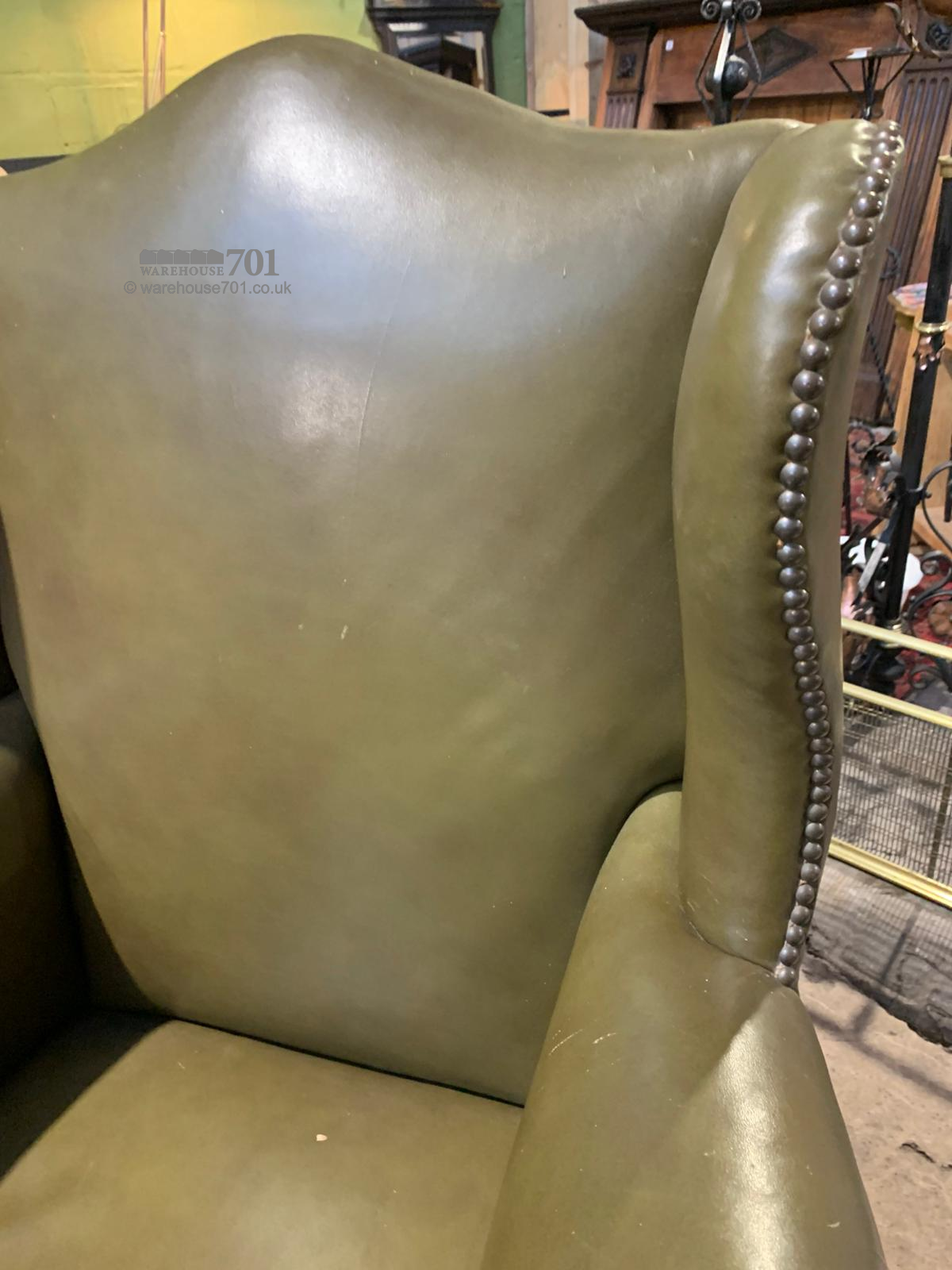 Vintage green leather wing back chair