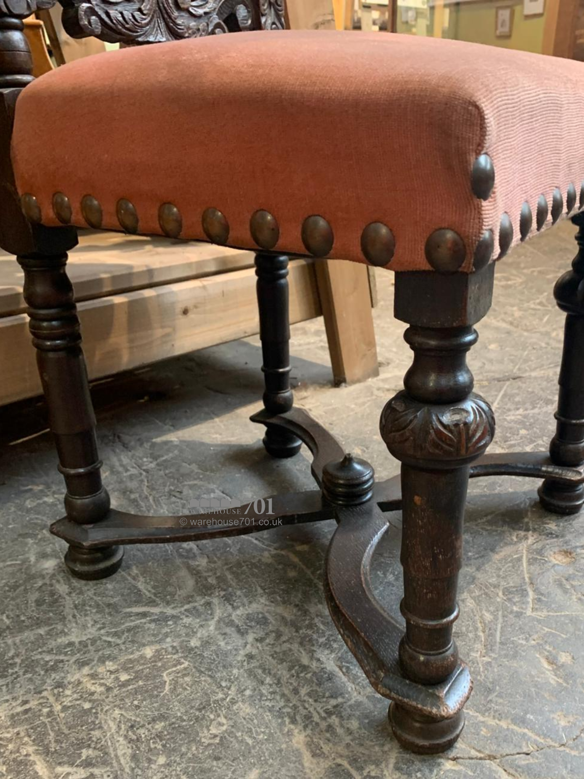 Dark wood relief carving chair with padded seat