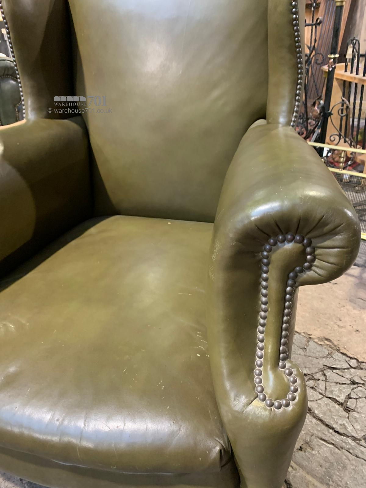 Vintage green leather wing back chair