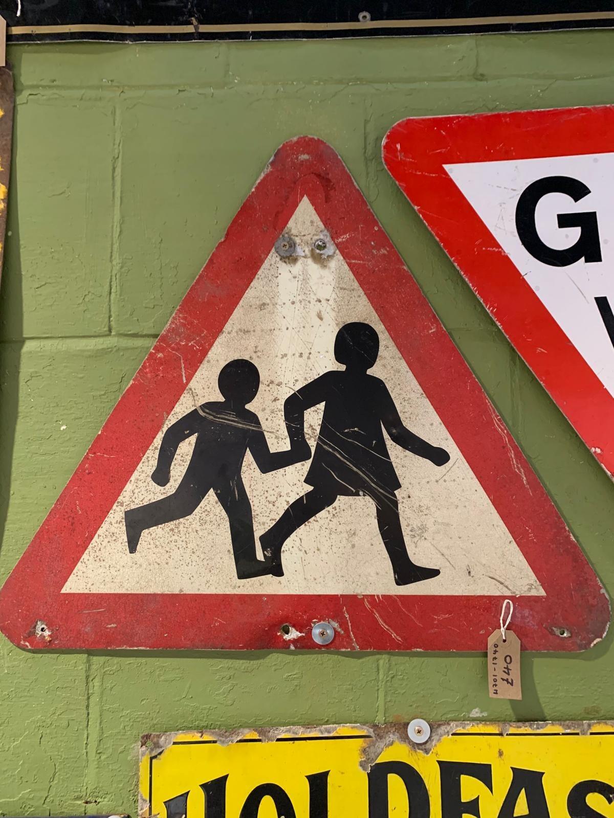 Metal children crossing triangle sign