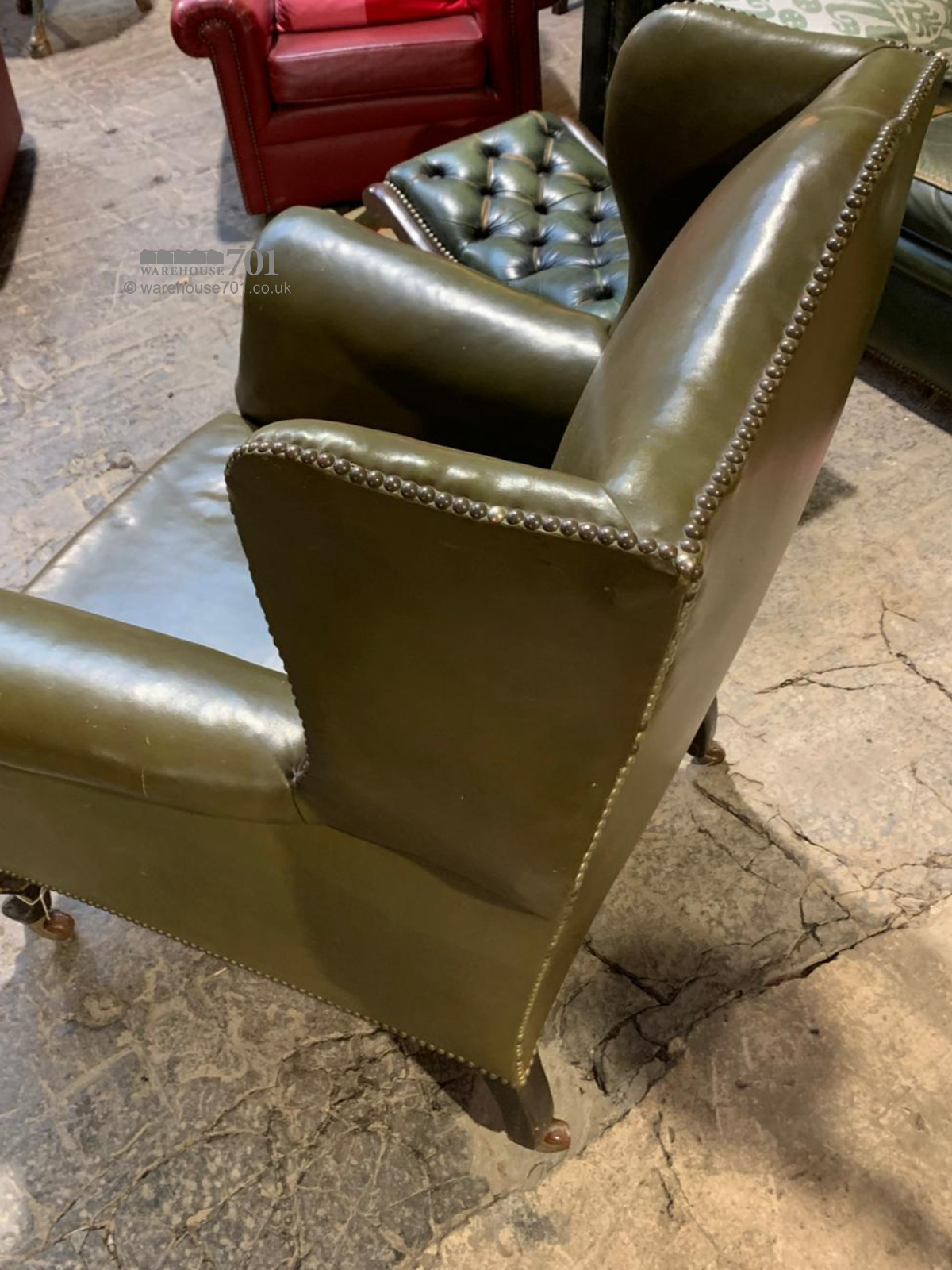 Vintage green leather wing back chair