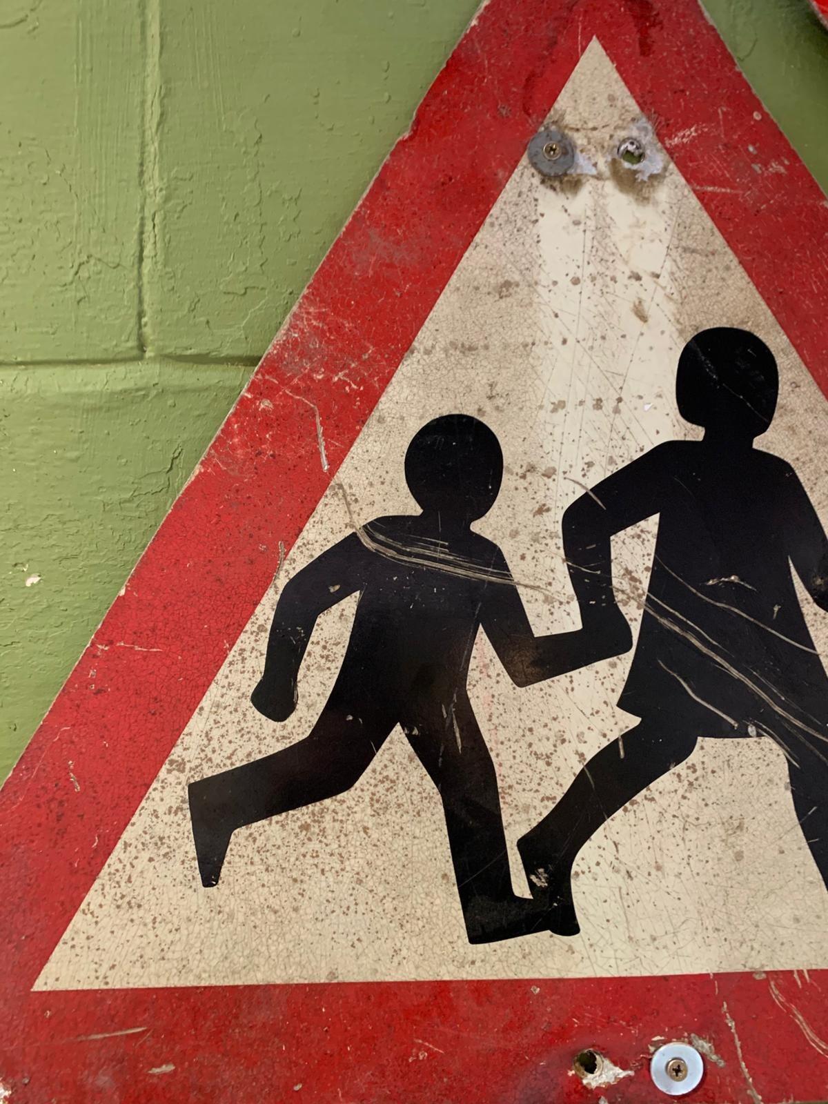 Metal children crossing triangle sign