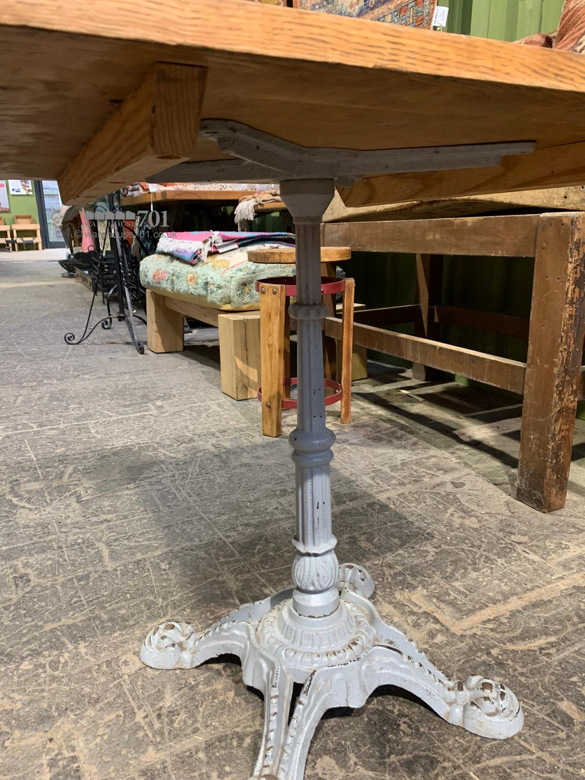 Reclaimed table with grey cast iron leg