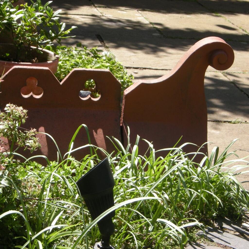 Swan neck ridge finials and architectural ridge tiles for roofs